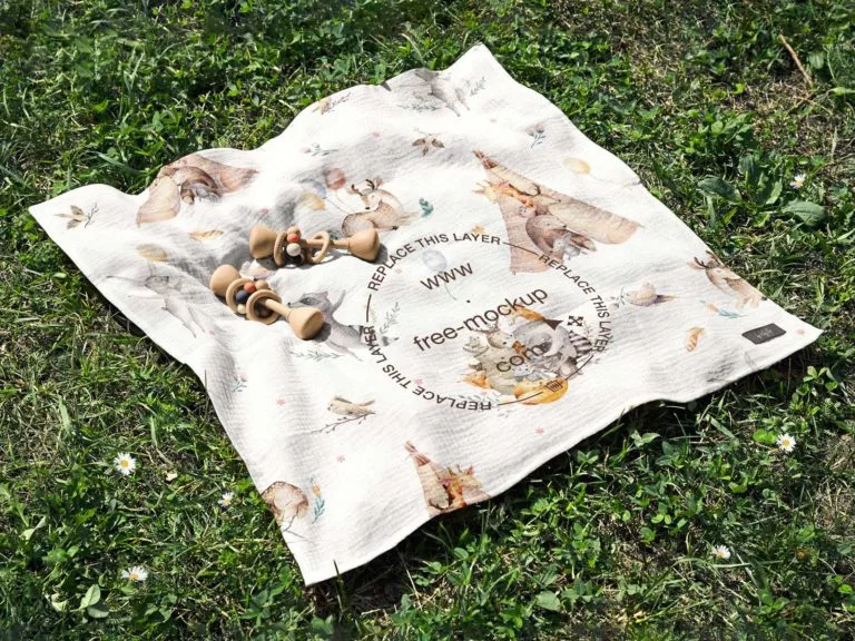 Cotton Muslin Swaddle Blanket Mockup on Grass | The Free Mockup