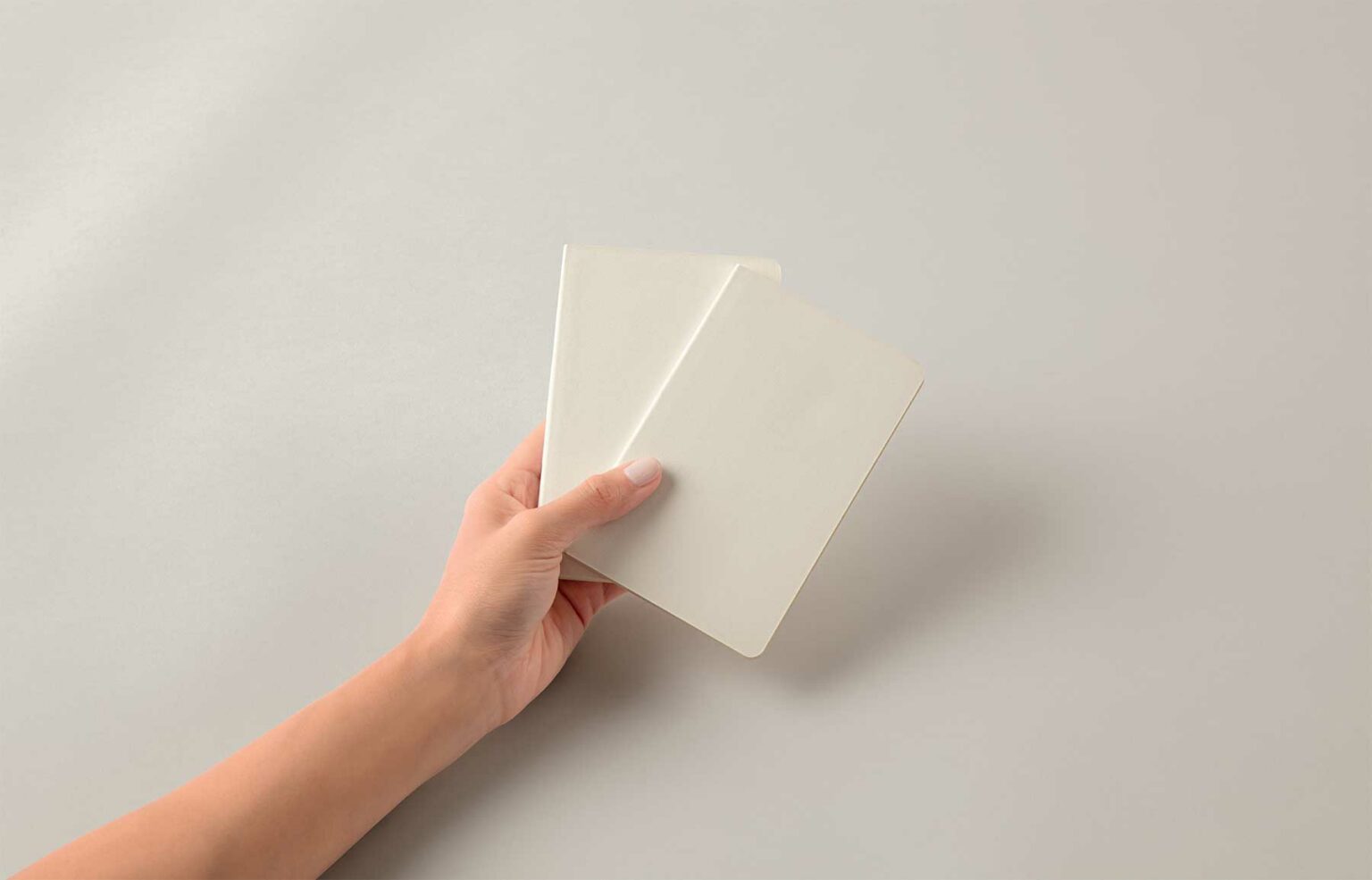 Hand Holding Pocket Notebook Mockups